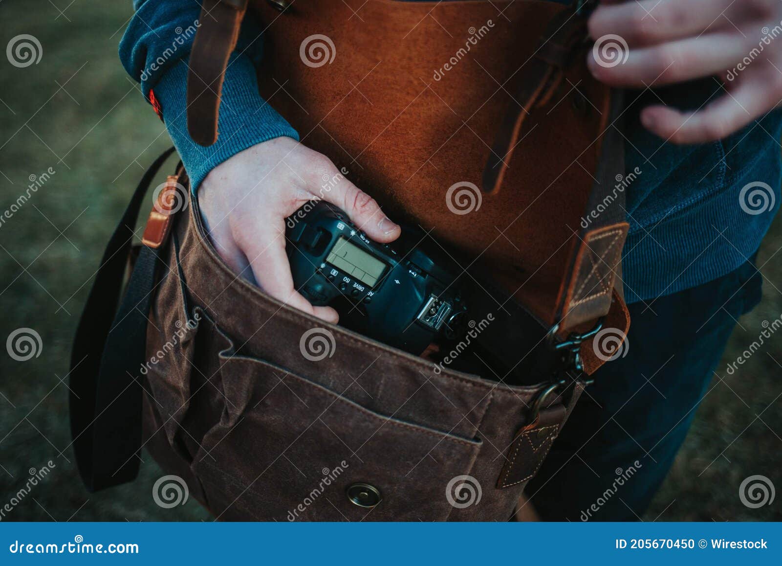 Photographer Taking the Camera Out of His Bag Stock Photo - Image of ...