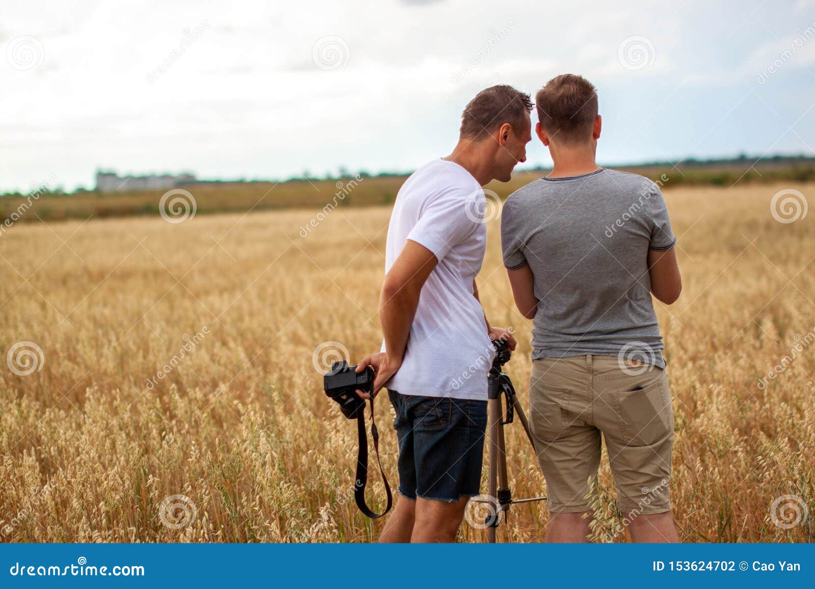 Photographers with Camera Looking at the Ground Outdoors. Stock Photo ...