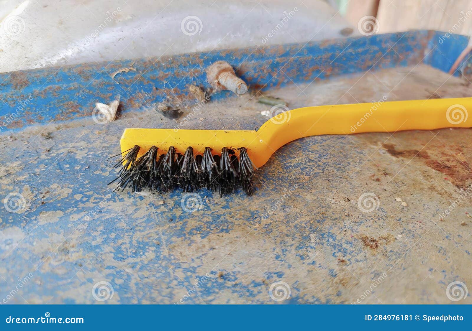 A Photography of a Brush and a Plastic Container on a Table, There is a ...