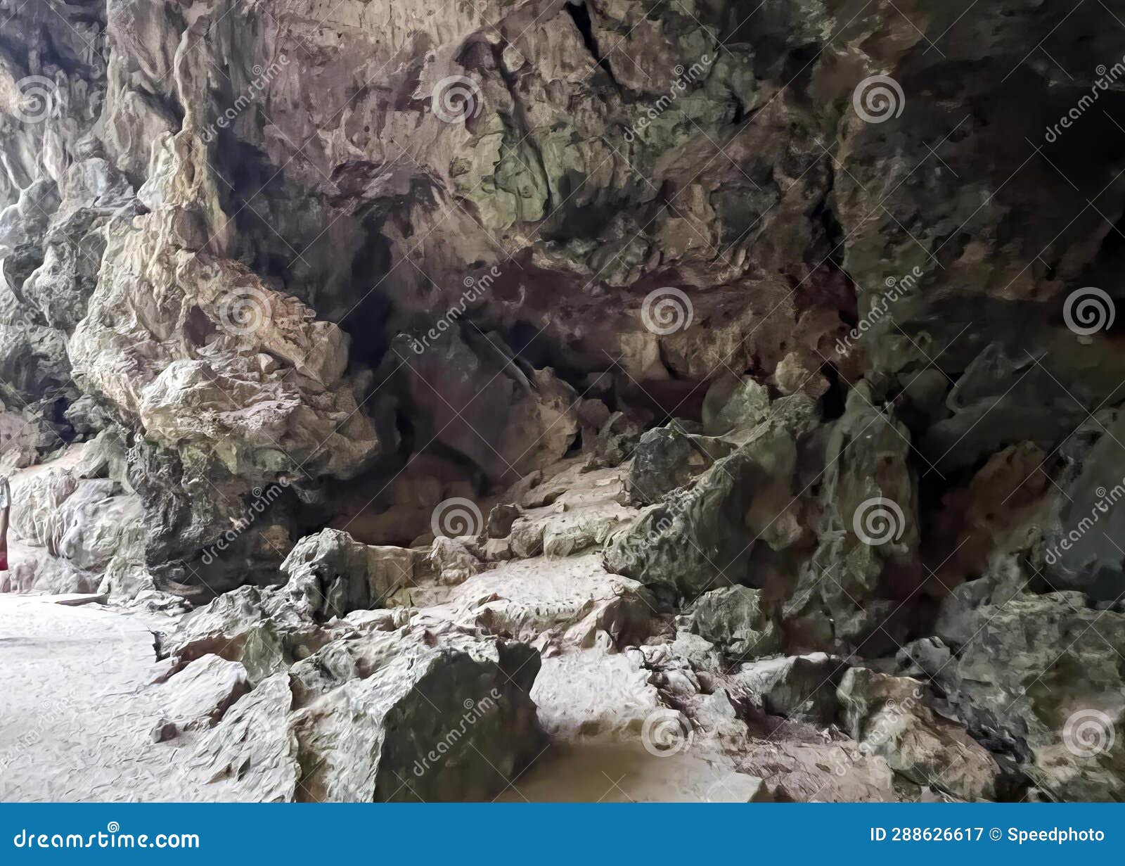 A Photography of a Person Walking through a Cave with a Backpack, Drop ...