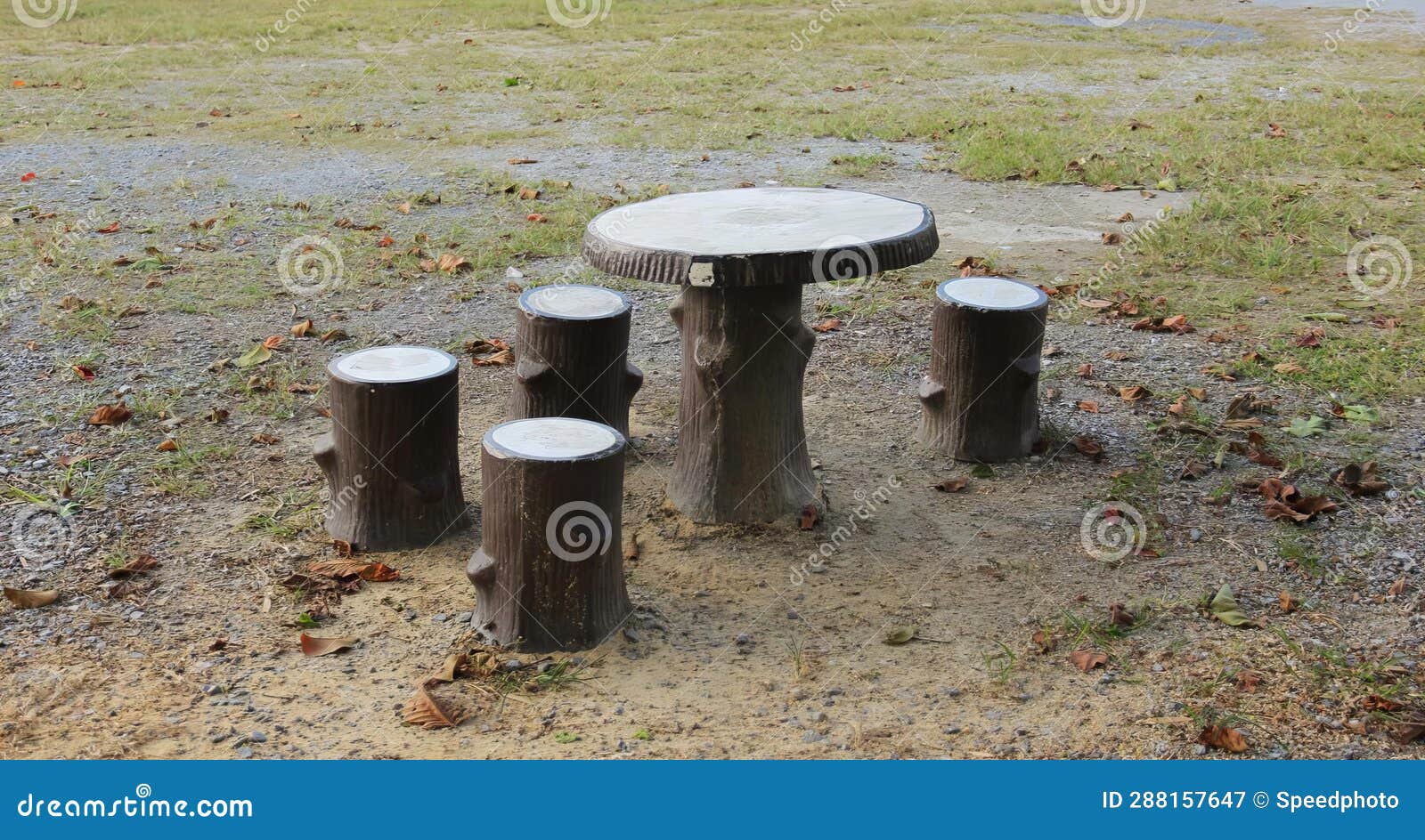 A Photography of a Table and Four Stools in a Field, Pole and Stump ...
