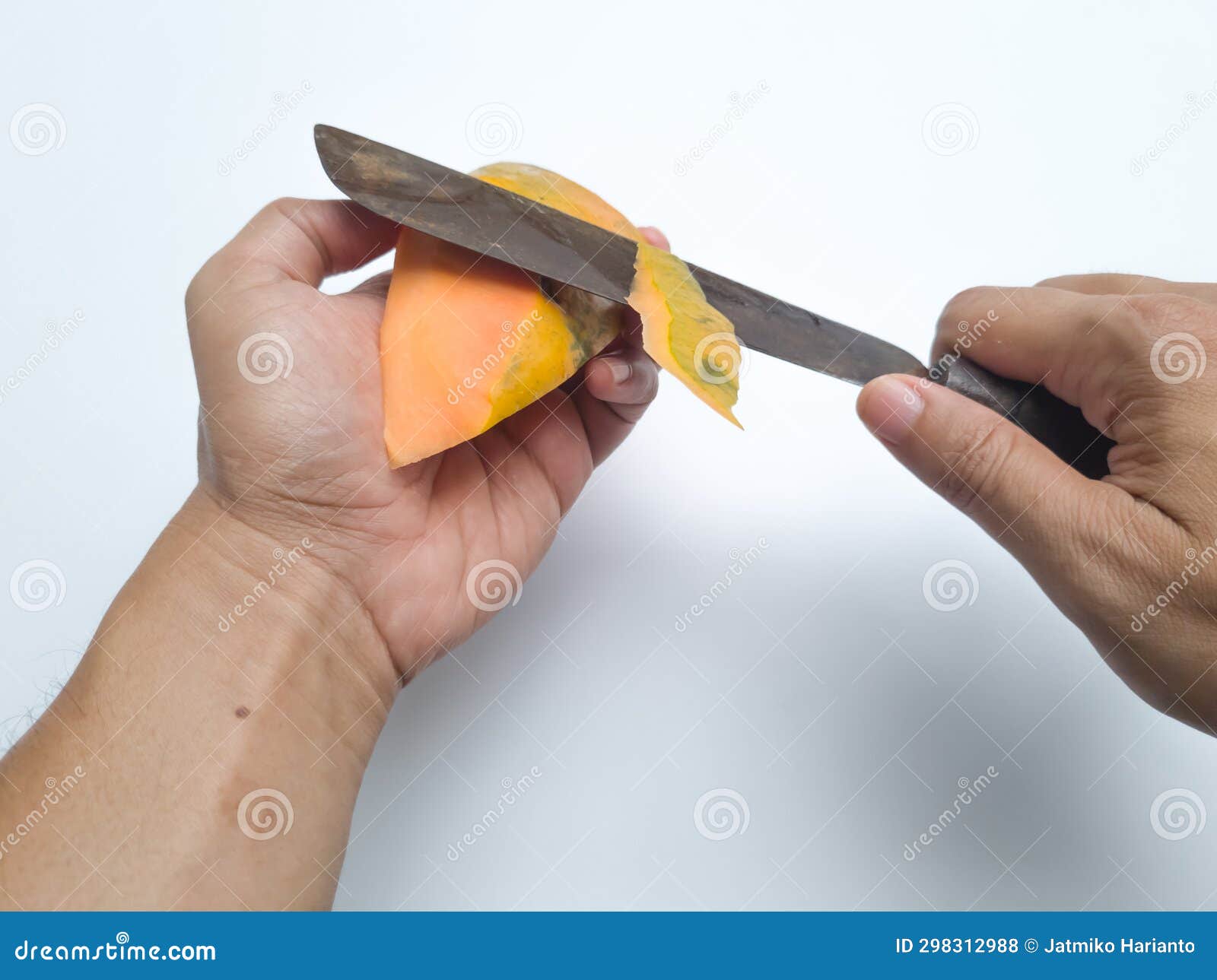 Man Cutting a Papaya Fruit with a Knife on a White Background, Isolate ...