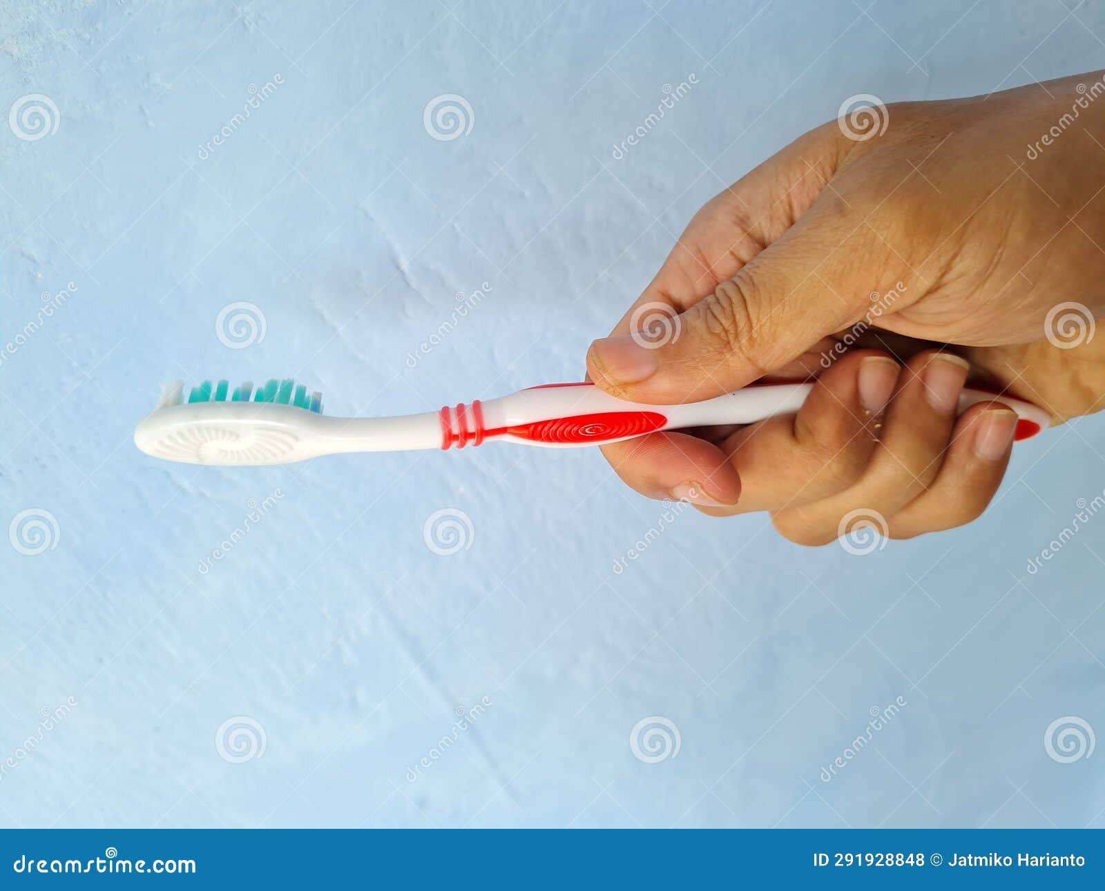 Toothbrush with a Combination of Red, White and Green on a Blue ...