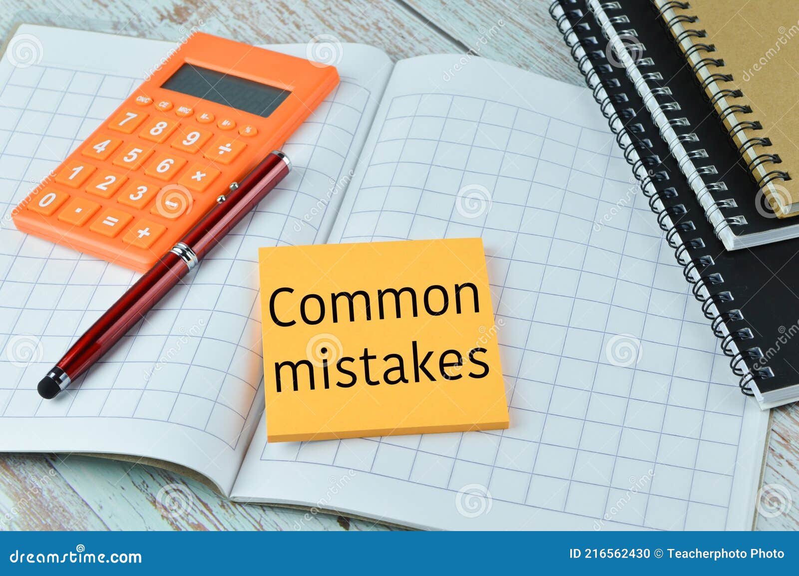 Phrase COMMON MISTAKES Written on Memo Note with Pens, Calculator and ...