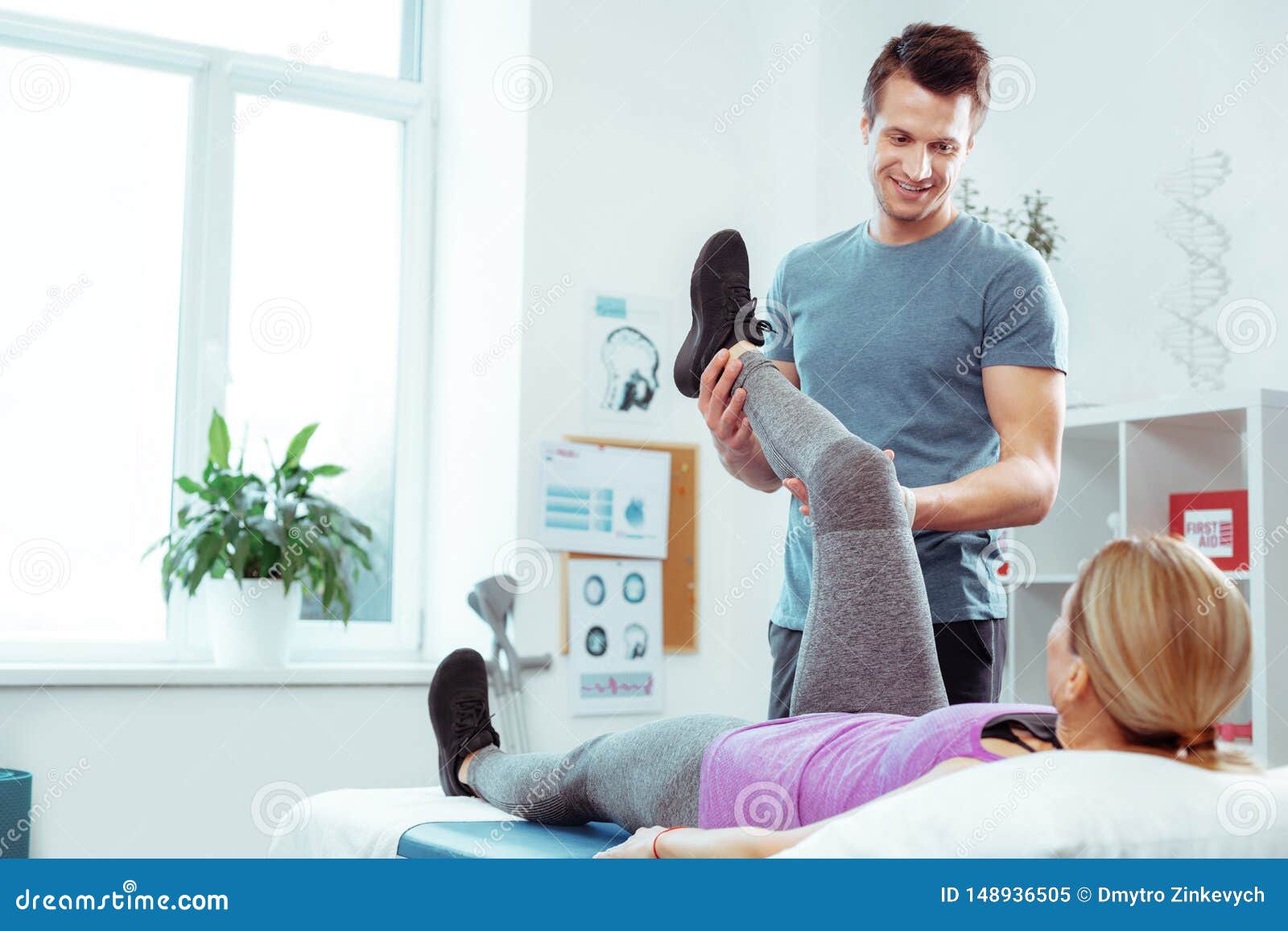 Joyful Positive Man Moving His Patients Leg Stock Image - Image of ... Joyful Positive Man Moving His Patients Leg Stock Image - Image of ...