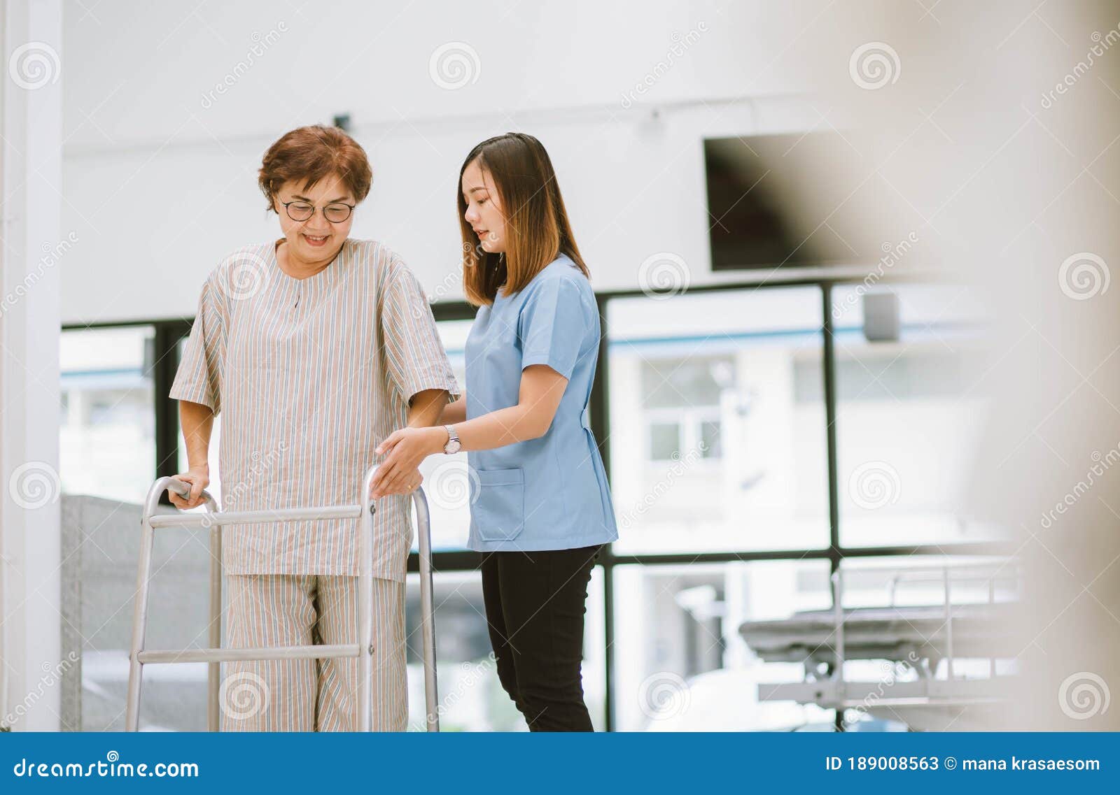 Physical Therapist Helping Senior Patient in Using Walker during ...