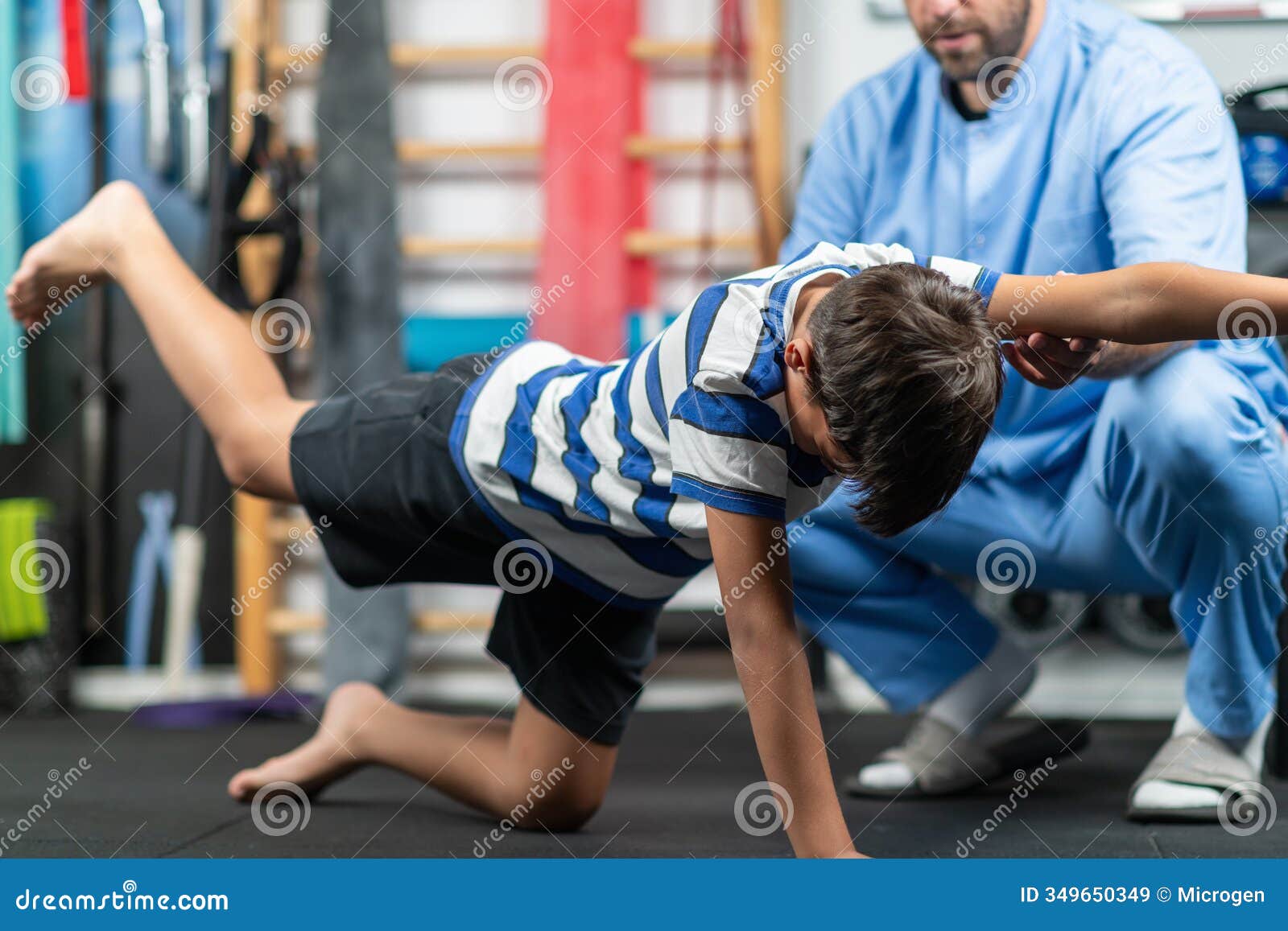 Physical Therapist Instructing a Young Boy in Exercises, Focusing on ...
