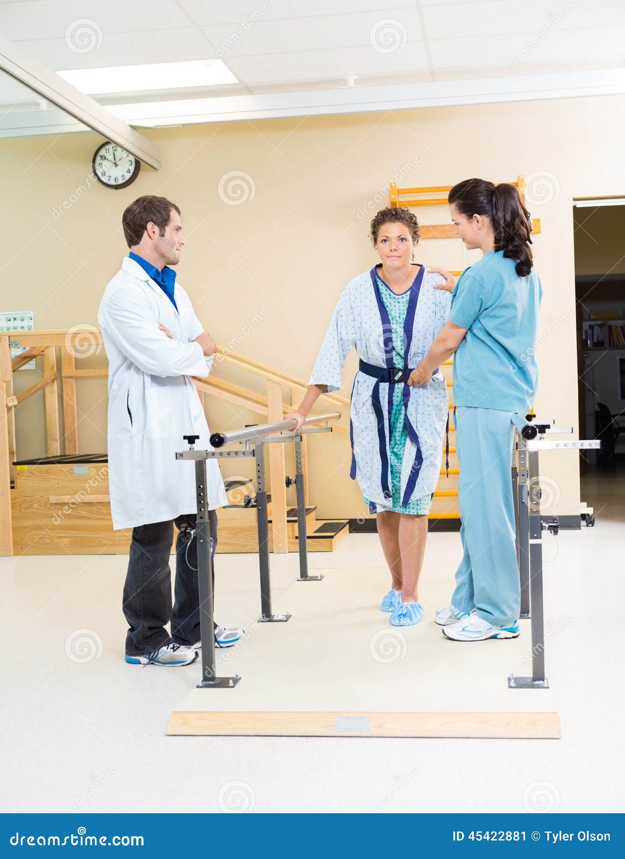 Physical Therapists Assisting Female Patient in Stock Image - Image of ...
