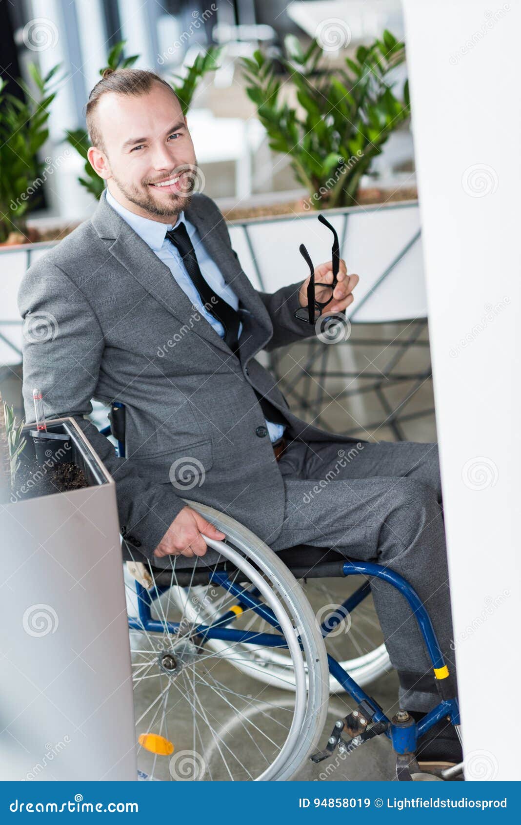Physically Handicapped Businessman Holding Glasses and Looking at ...