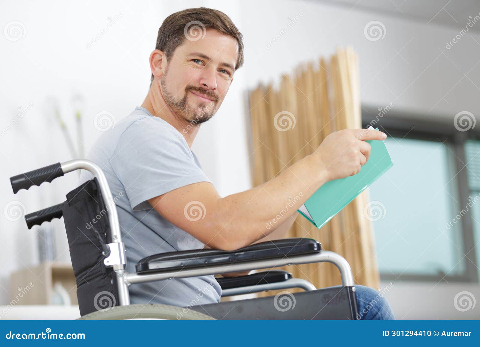 Physically Handicapped Man in Wheelchair with Book Stock Photo - Image ...