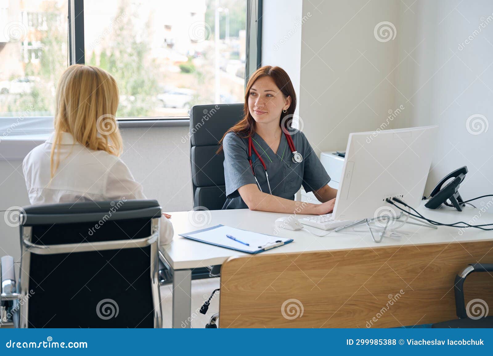 Doctor Entering Patient Data into Electronic Health Record during ...