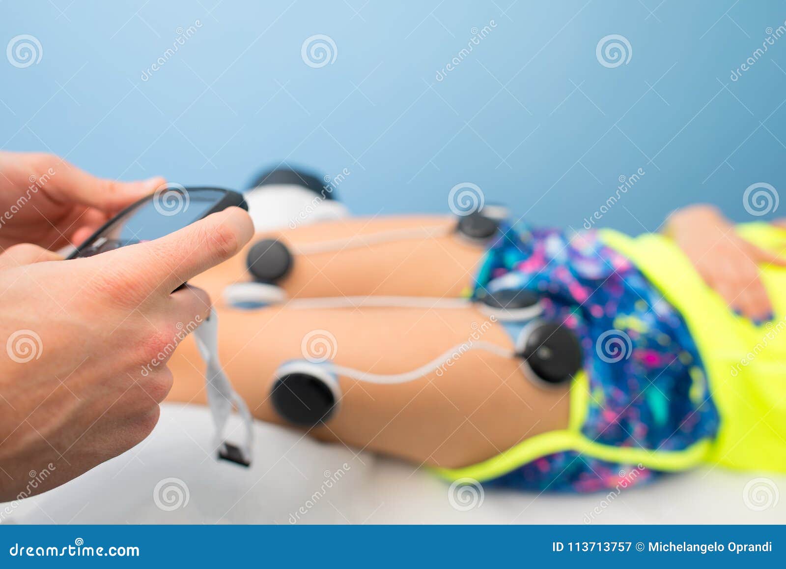 Physiotherapist Controls Electrostimulation Action at the Quadriceps of ...