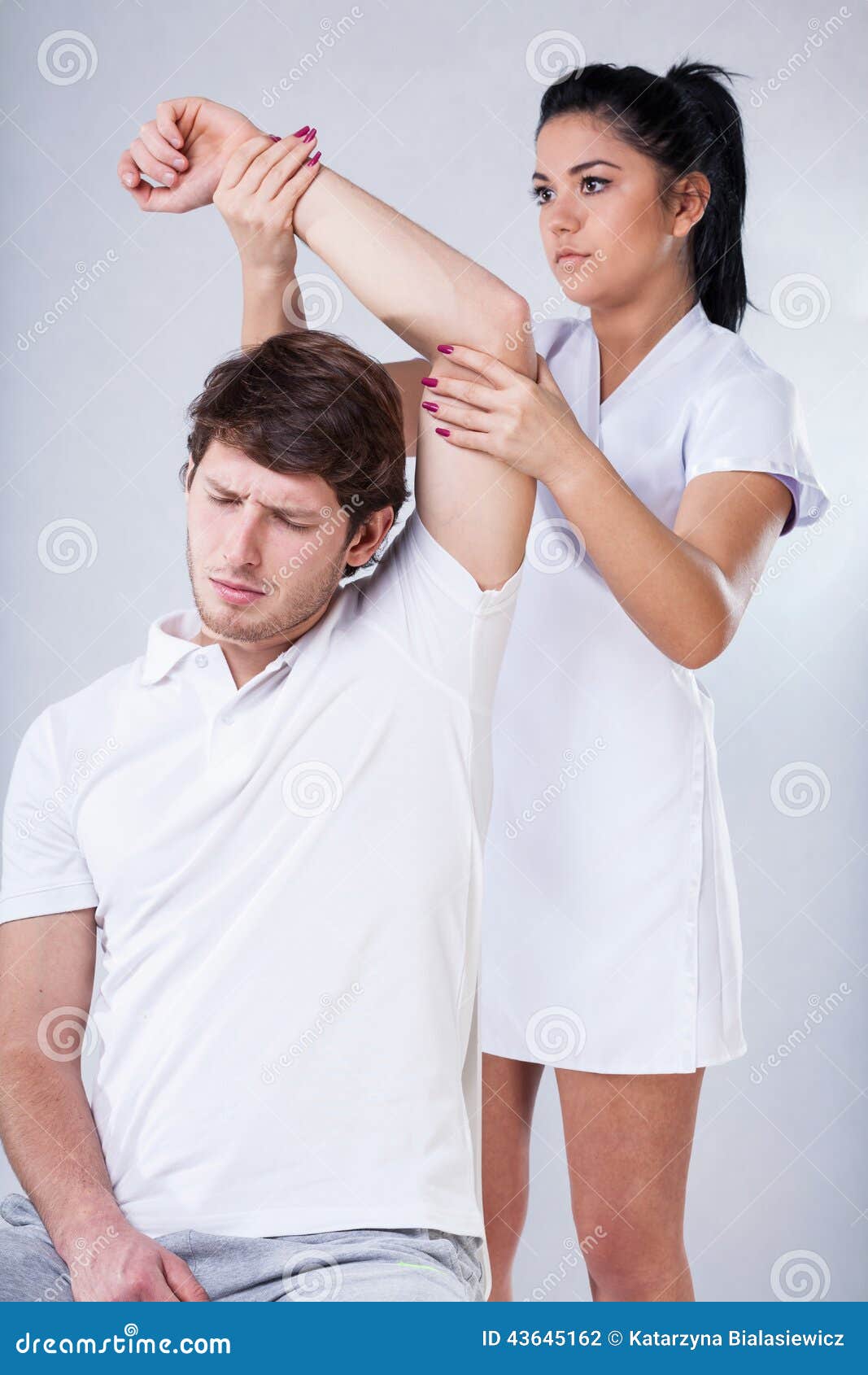 Physiotherapist Diagnosing Patient with Painful Shoulder Stock Photo ...
