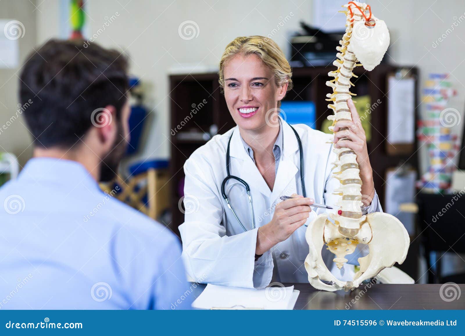 Physiotherapist Explaining Spine Model To Patient Stock Photo - Image ...