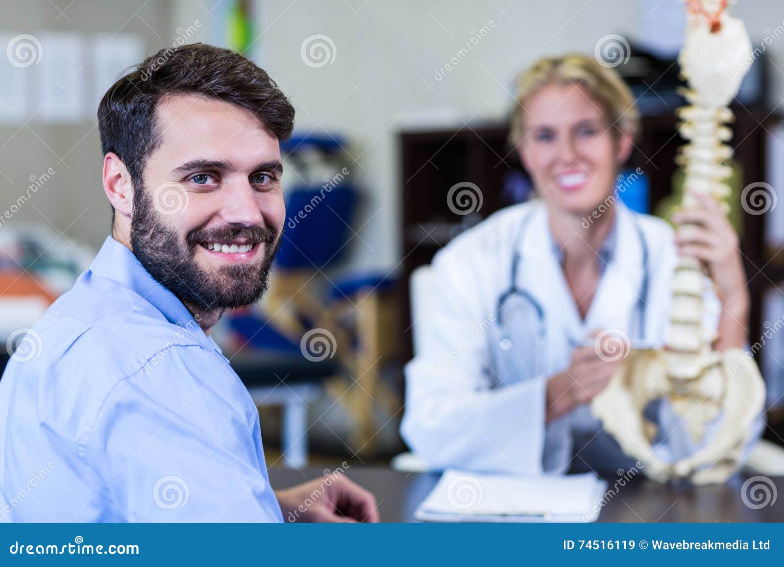 Physiotherapist Explaining Spine Model To Patient Stock Image - Image ...