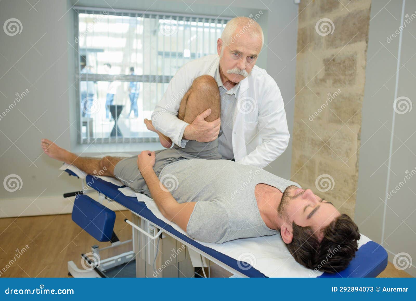 Physiotherapist Manipulating Mans Leg Stock Image - Image of young ...