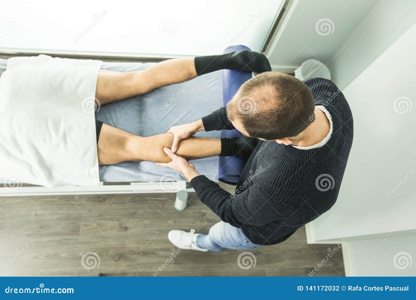 Physiotherapist Massaging A Young Man Calf Physiotherapy And