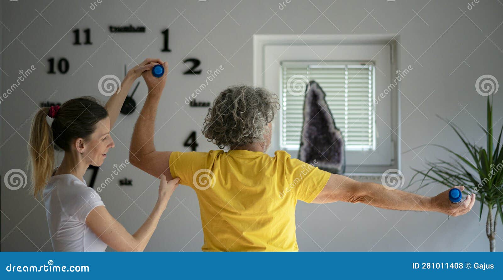 Physiotherapist or Professional Personal Trainer Helping a Senior Man ...