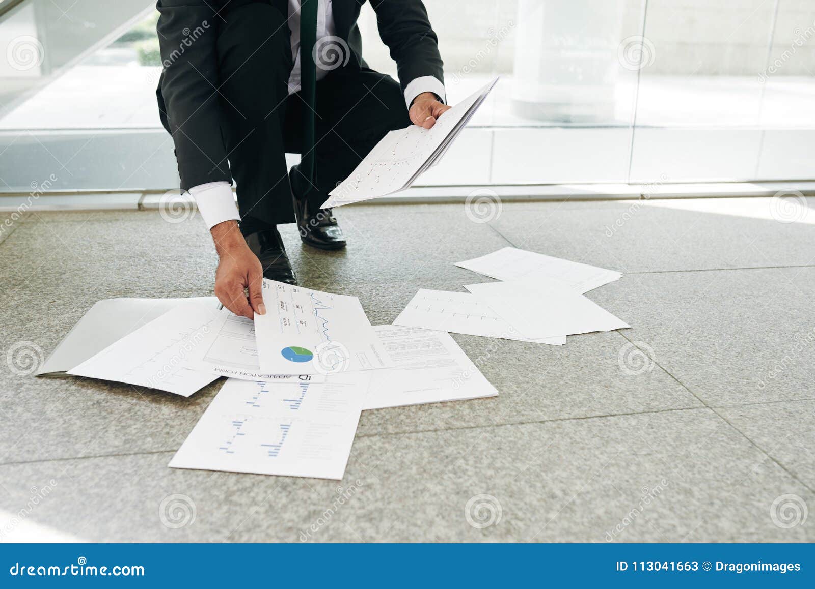 Picking documents up stock image. Image of crouching - 113041663