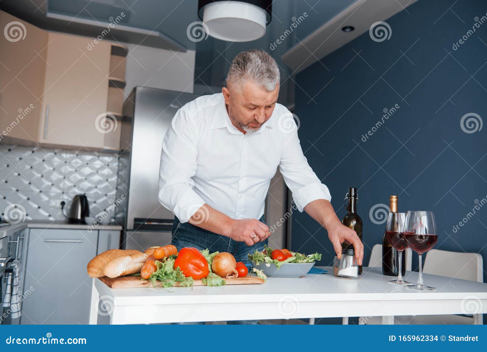 Picking Some Salt. Man in White Shirt Preparing Food on the Kitchen ...