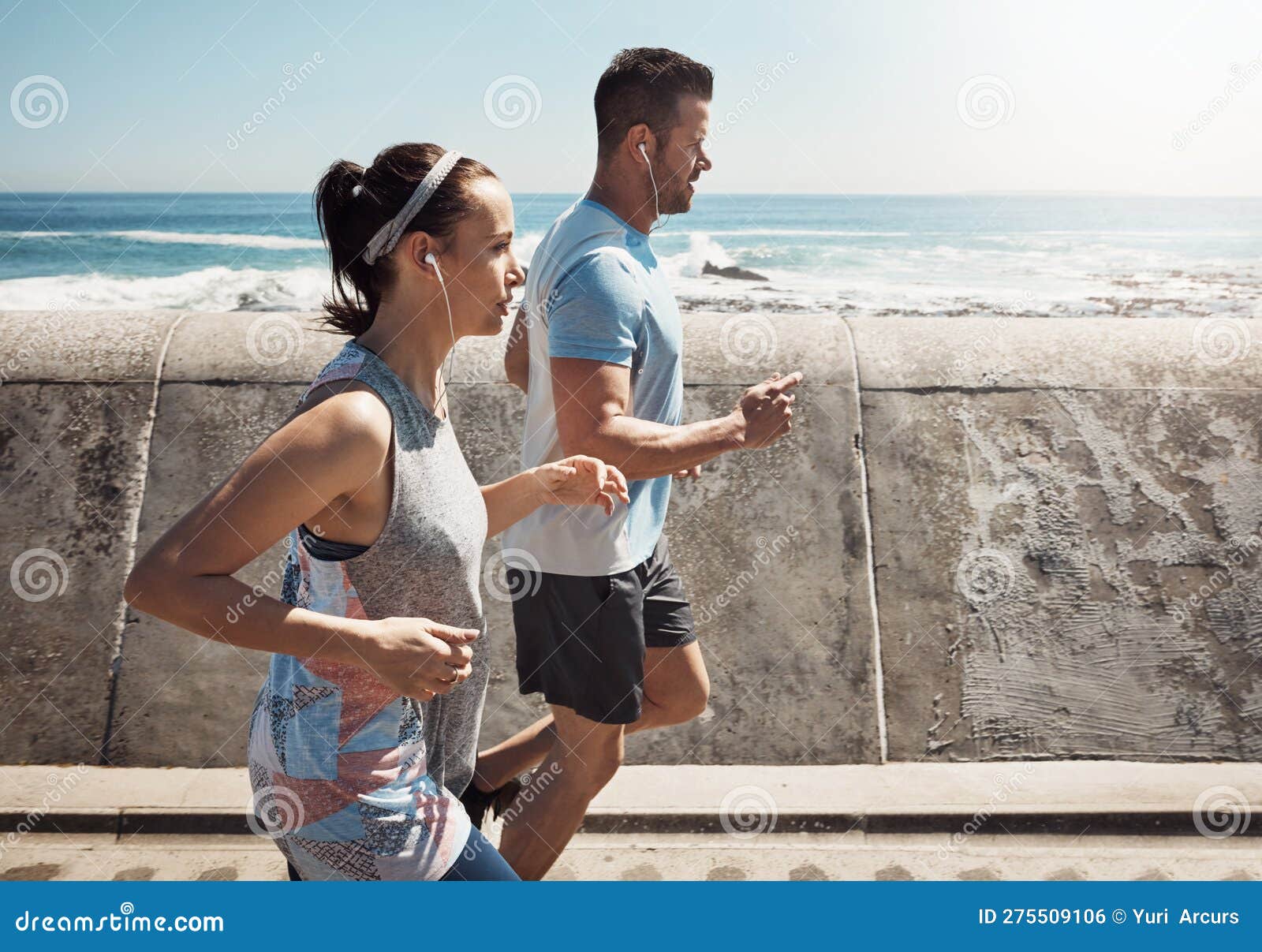 Picking Up the Pace. a Young Couple Out for a Run on the Promenade ...