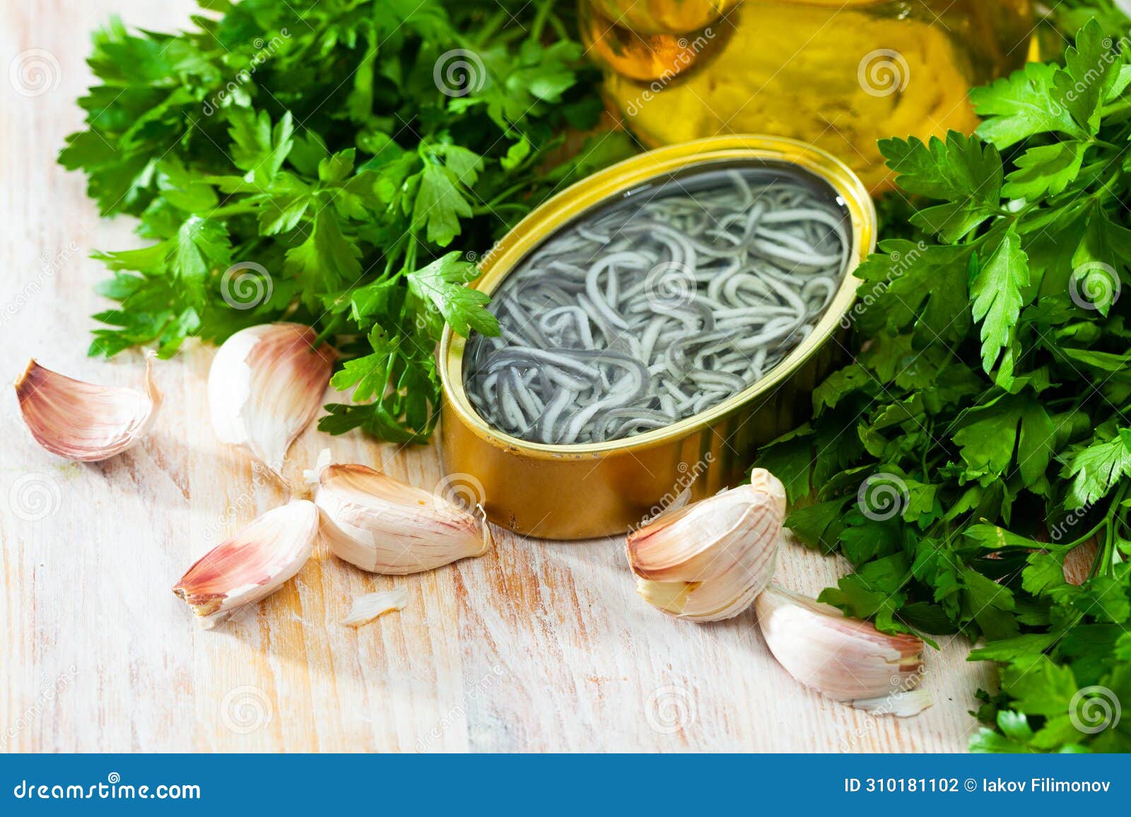 Pickled Eels in Open Tin Can with Garlic at Table Stock Photo - Image ...