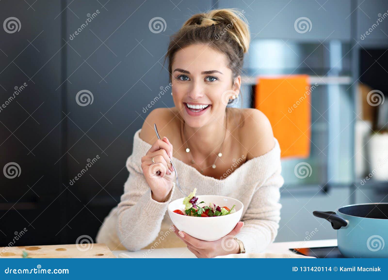 Beautiful Smiling Woman Eating Fresh Organic Vegetarian Salad In Modern