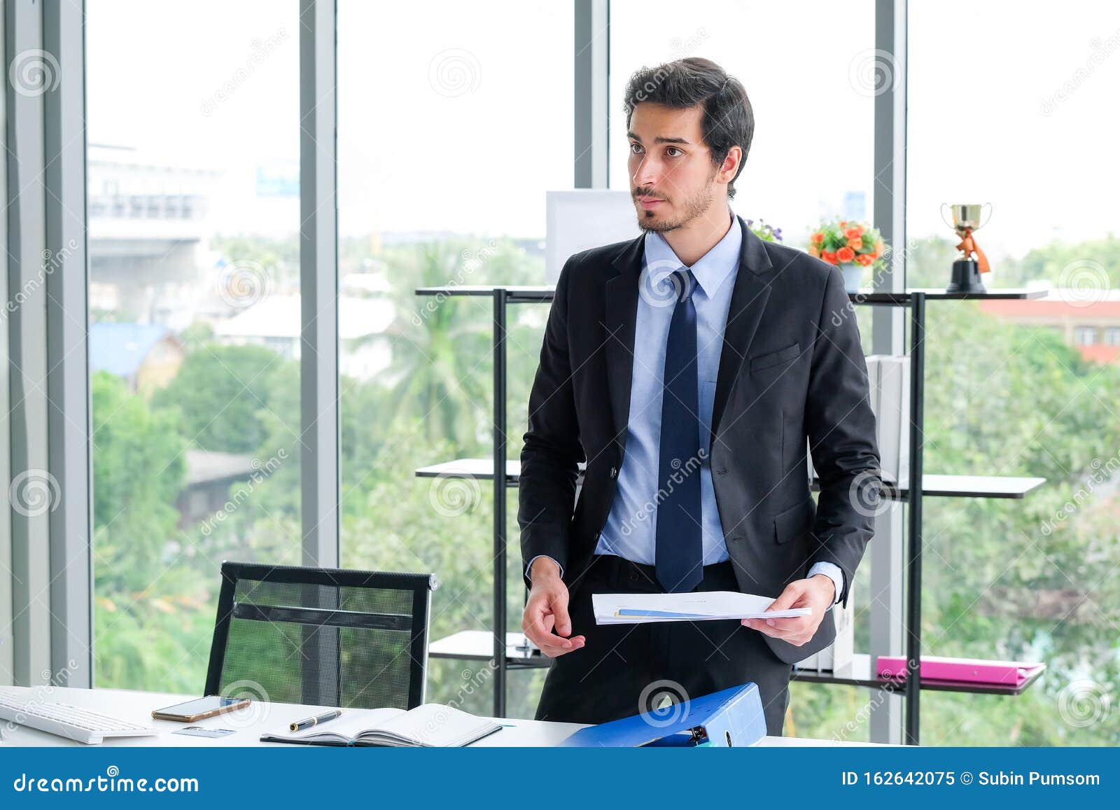 A Picture of a Business Man at Desk Using Documents Stock Image - Image ...