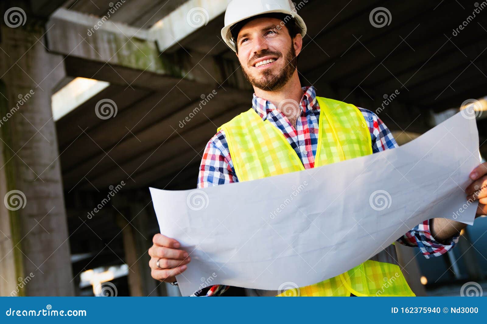 Picture of Construction Site Engineer Looking at Blueprint Stock Photo ...