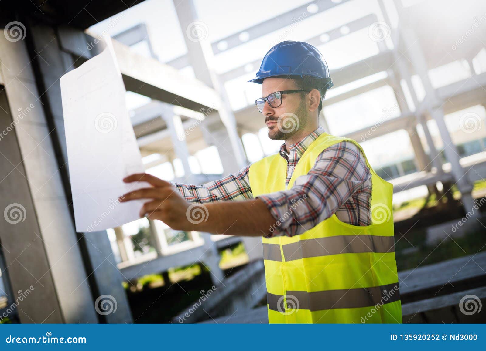 Picture of Construction Site Engineer Looking at Plan Stock Photo ...