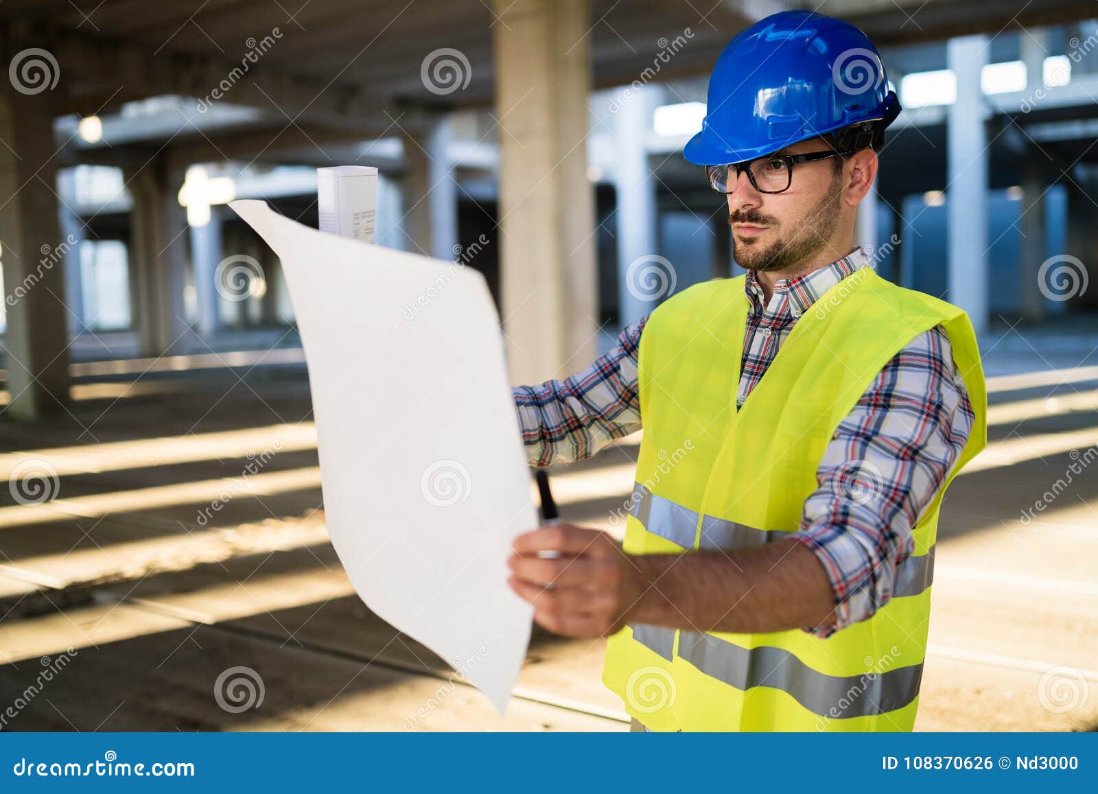Picture of Construction Site Engineer Looking at Plan Stock Photo ...