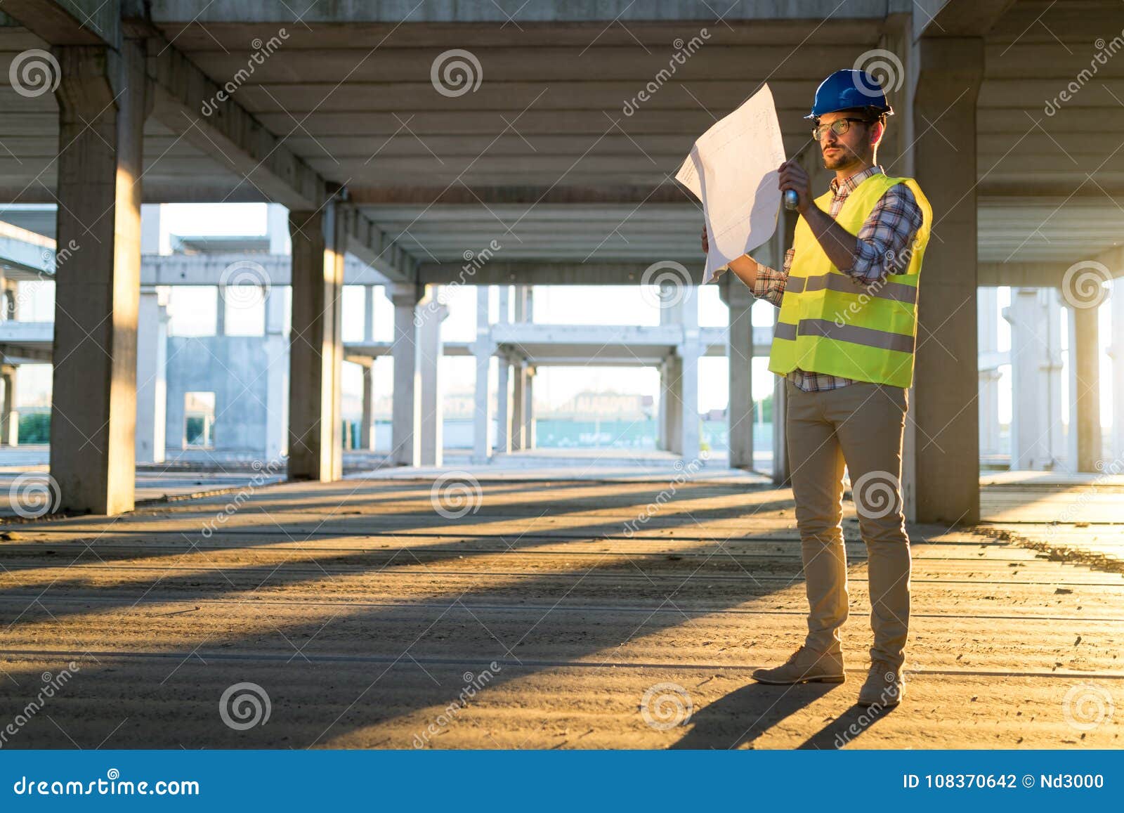 Picture of Construction Site Engineer Looking at Plan Stock Photo ...