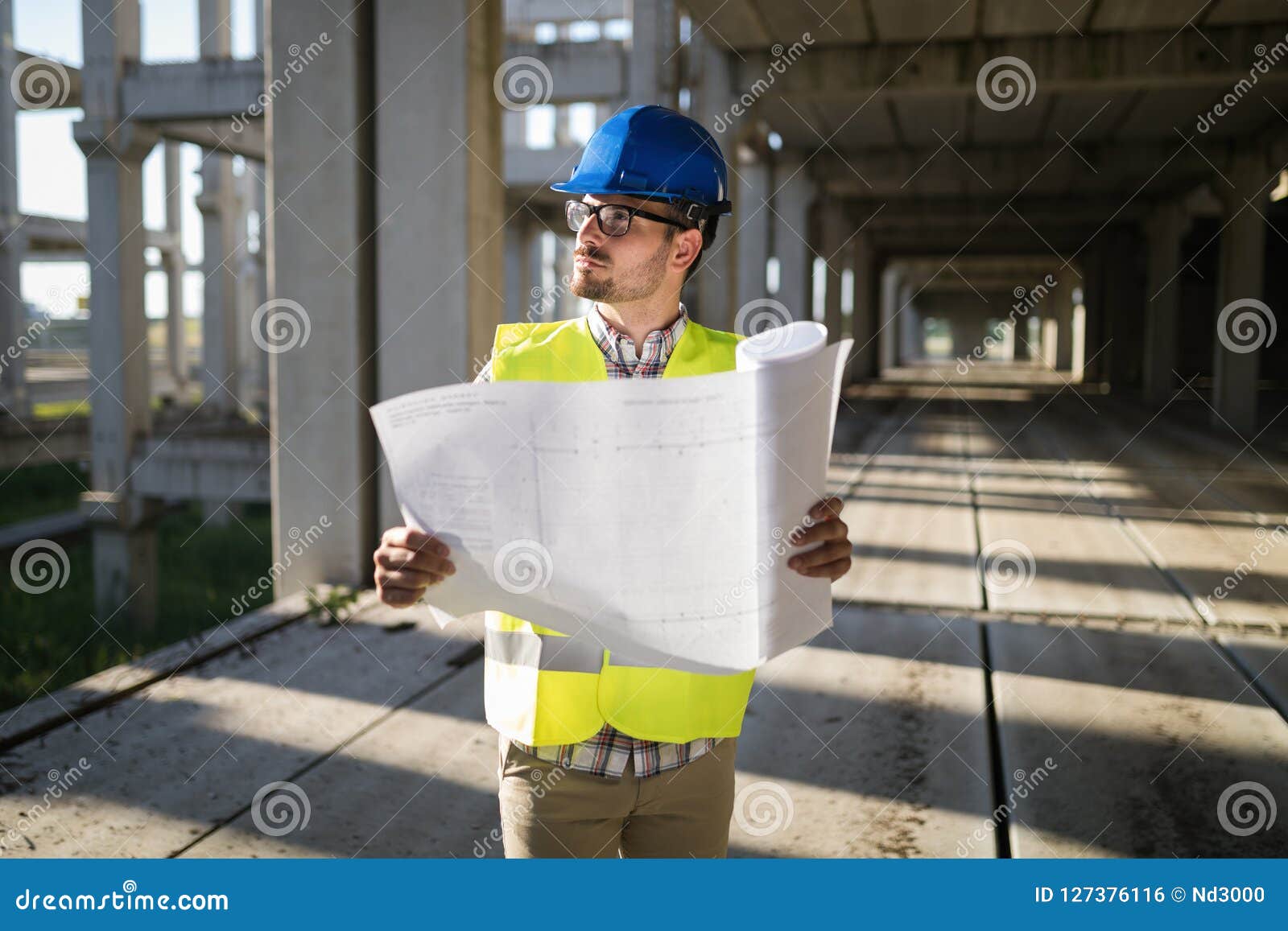 Picture of Construction Site Engineer Looking at Plan Stock Photo ...