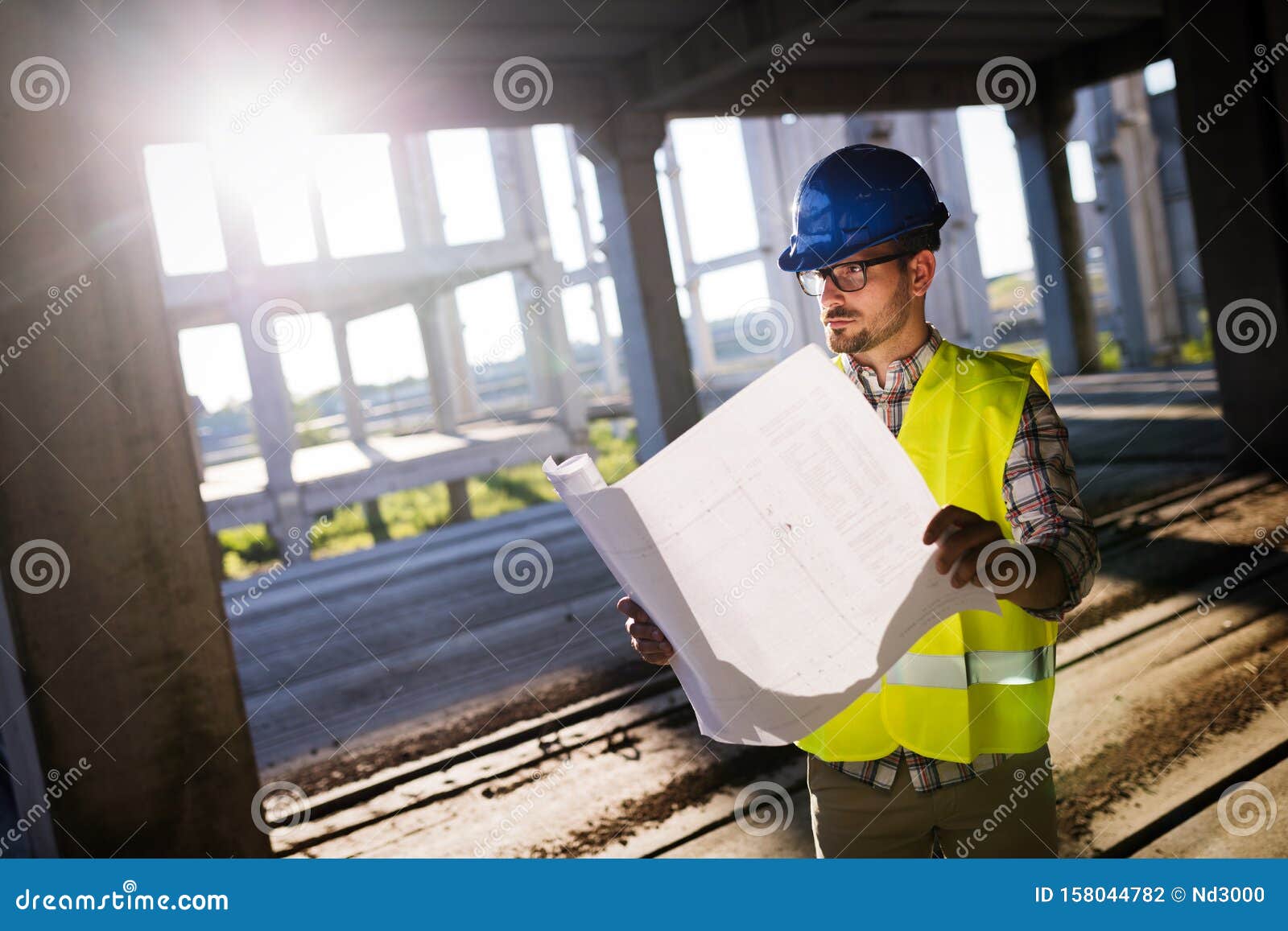 Picture of Construction Site Engineer Looking at Plan Stock Photo ...