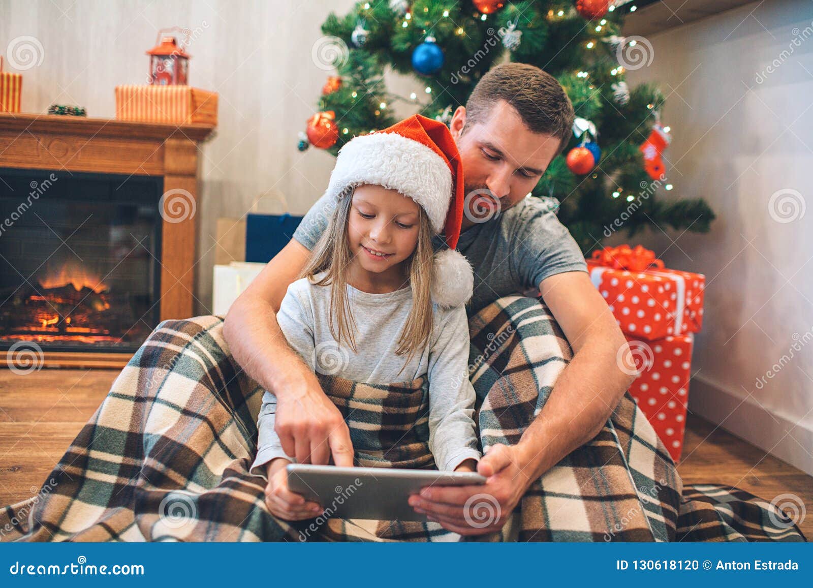 Picture of Father Sitting Together with Daughter and Looking at Tablet ...