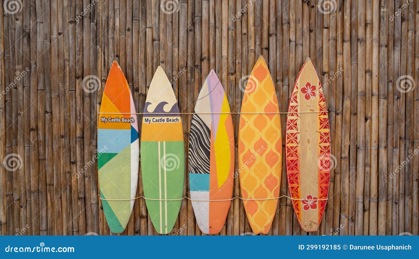 A Picture of Five Surfboards Resting Against a Brown Bamboo Wall. Stock ...