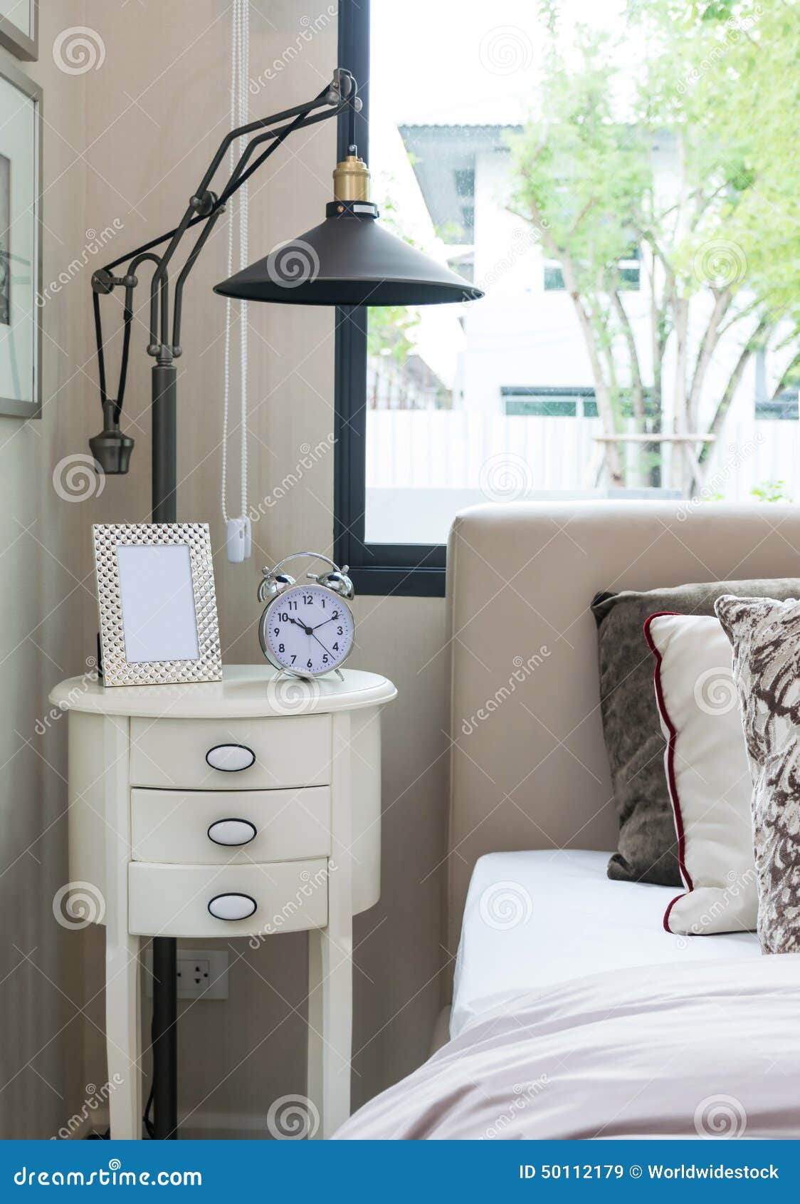 Picture Frame and Alarm Clock on Bedside Table Stock Image - Image of ...