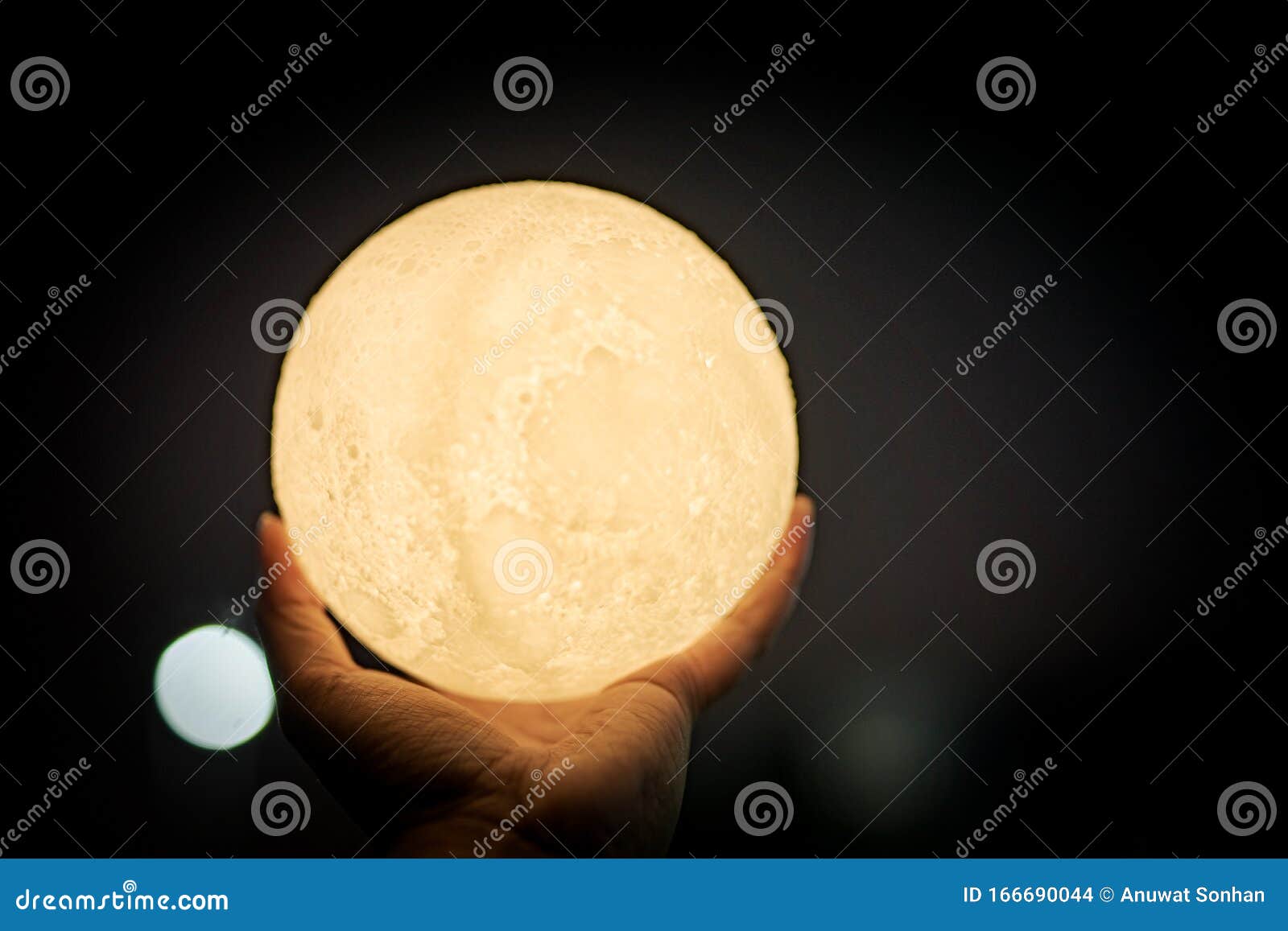 A Picture of a Hand Holding a Model of the Moon at Night Stock Photo ...
