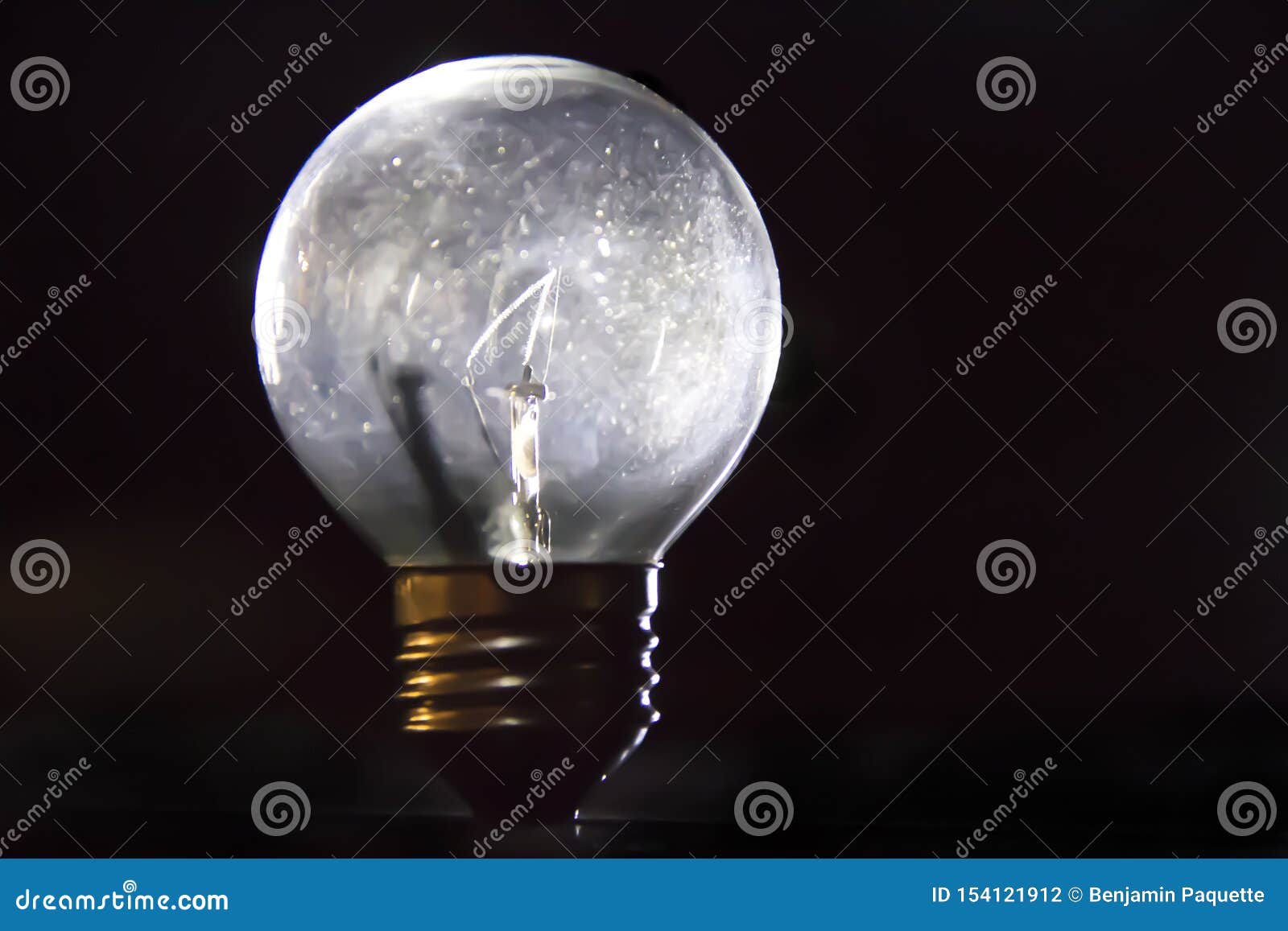 Lightbulb in Front of a Spotlight Stock Photo - Image of bulb, isolated ...
