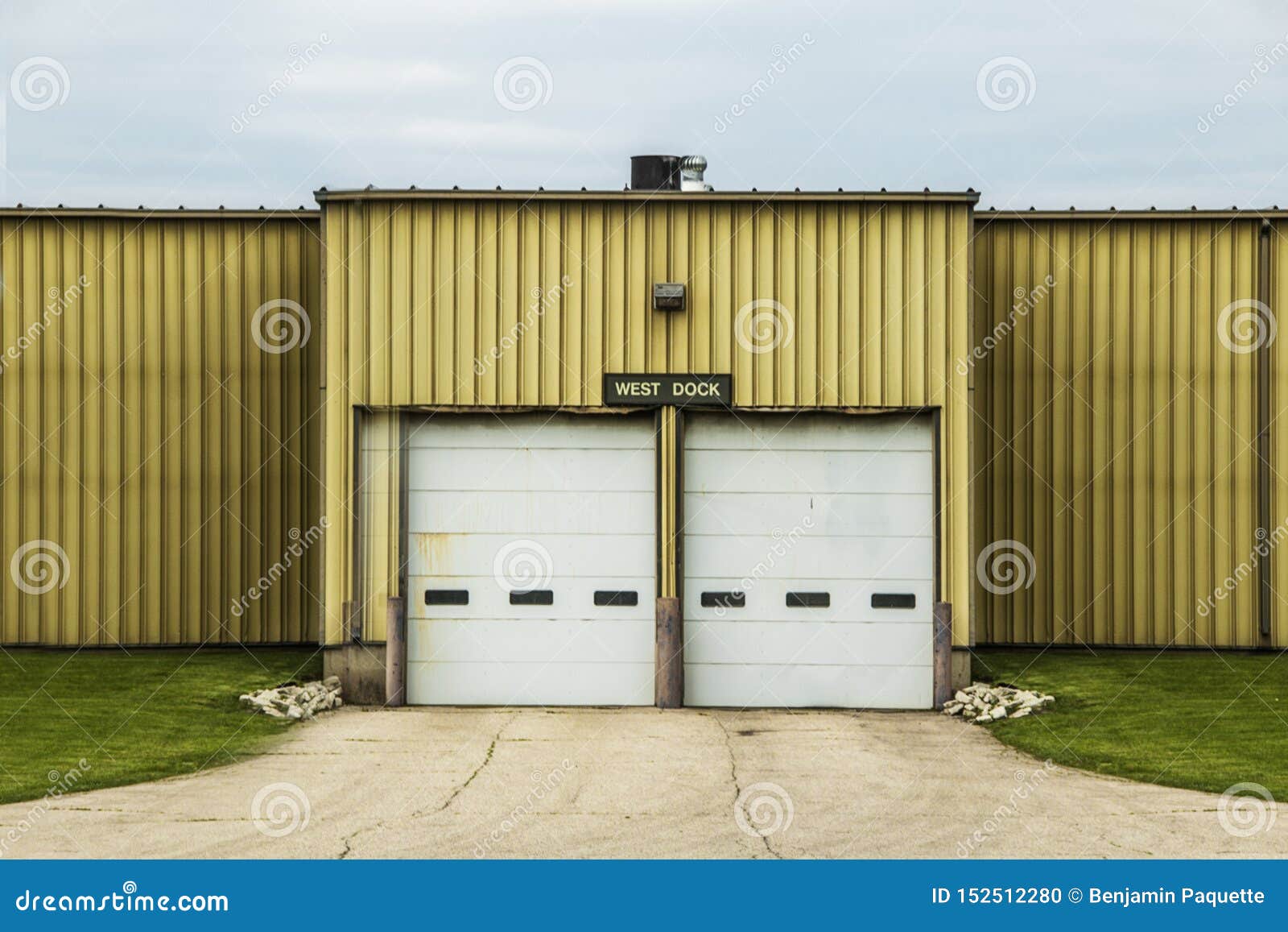 Loading Dock Doors at a Yellow Warehouse Building Stock Photo - Image ...