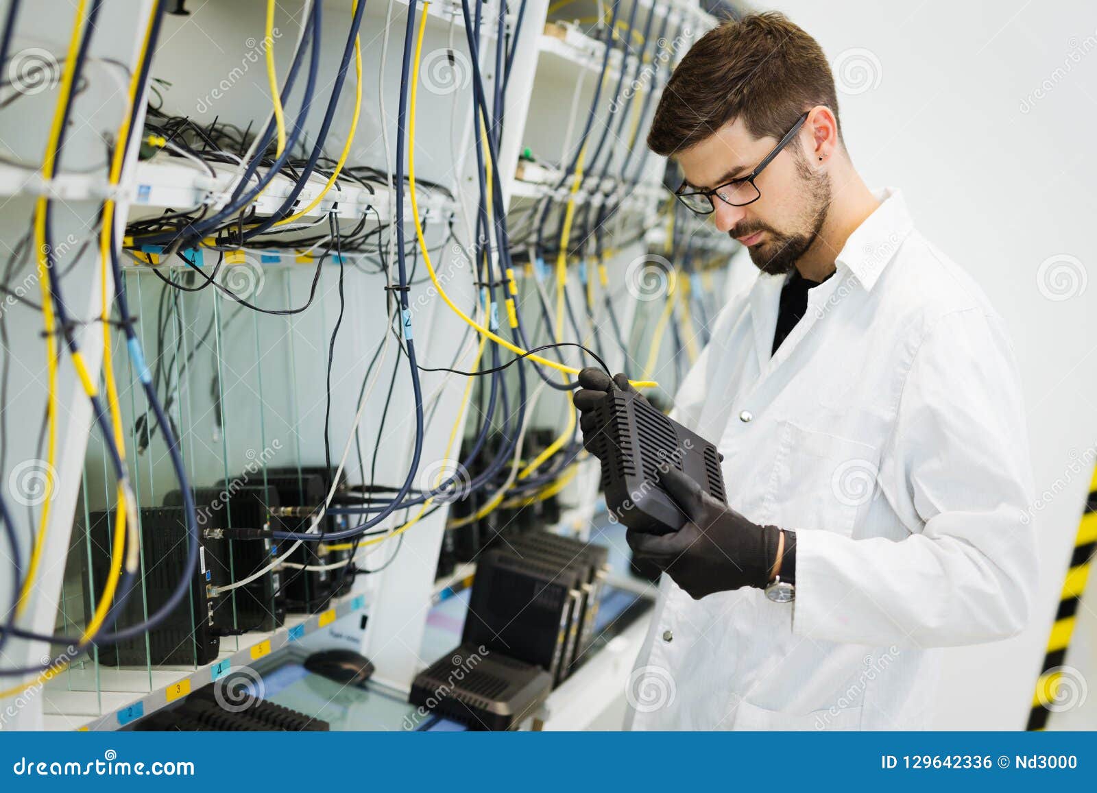 Picture of Network Technician Testing Modems in Factory Stock Photo ...