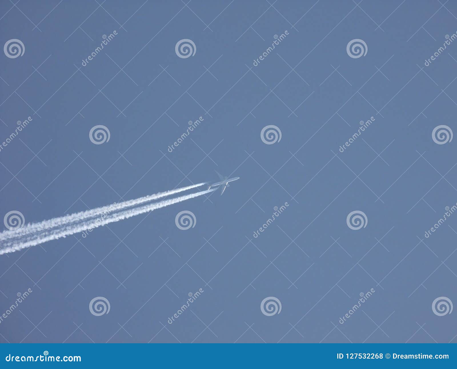 Jet plane in the blue sky stock photo. Image of trace - 127532268