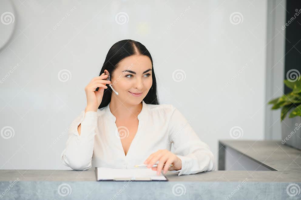 Picture of Pretty Receptionist at Work. Stock Image - Image of computer ...