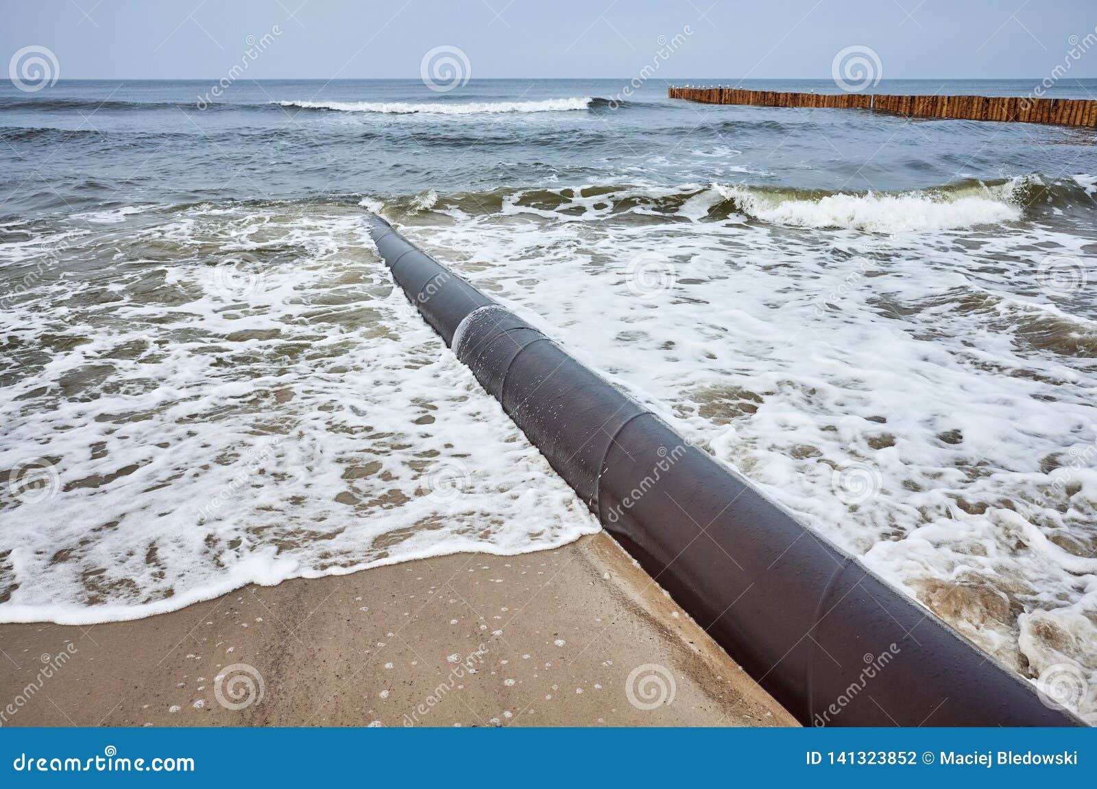 Rusty pipeline on a beach stock photo. Image of coast - 141323852