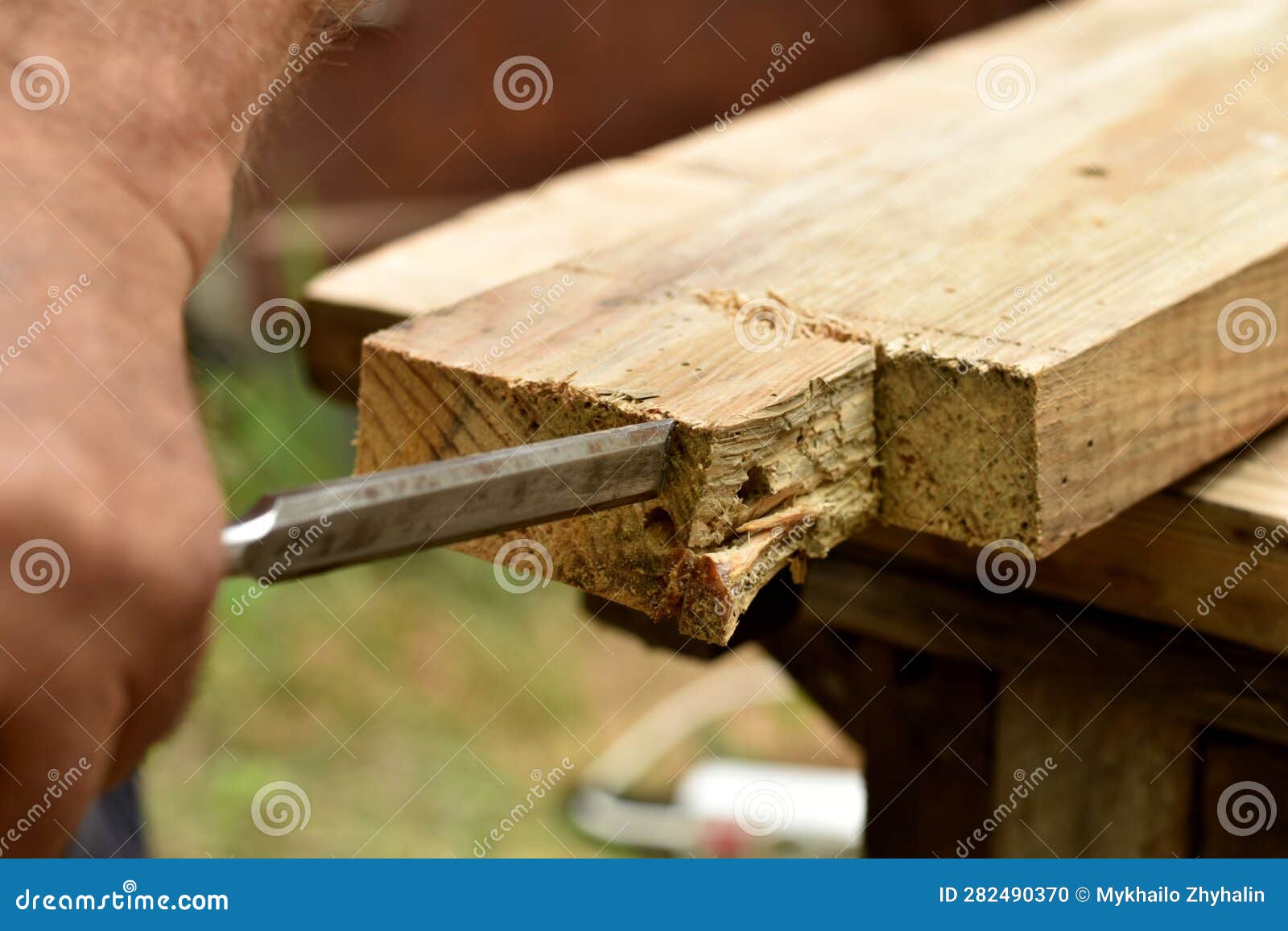 The Working Moment of the Carpenter S Work with a Chisel with a Board ...