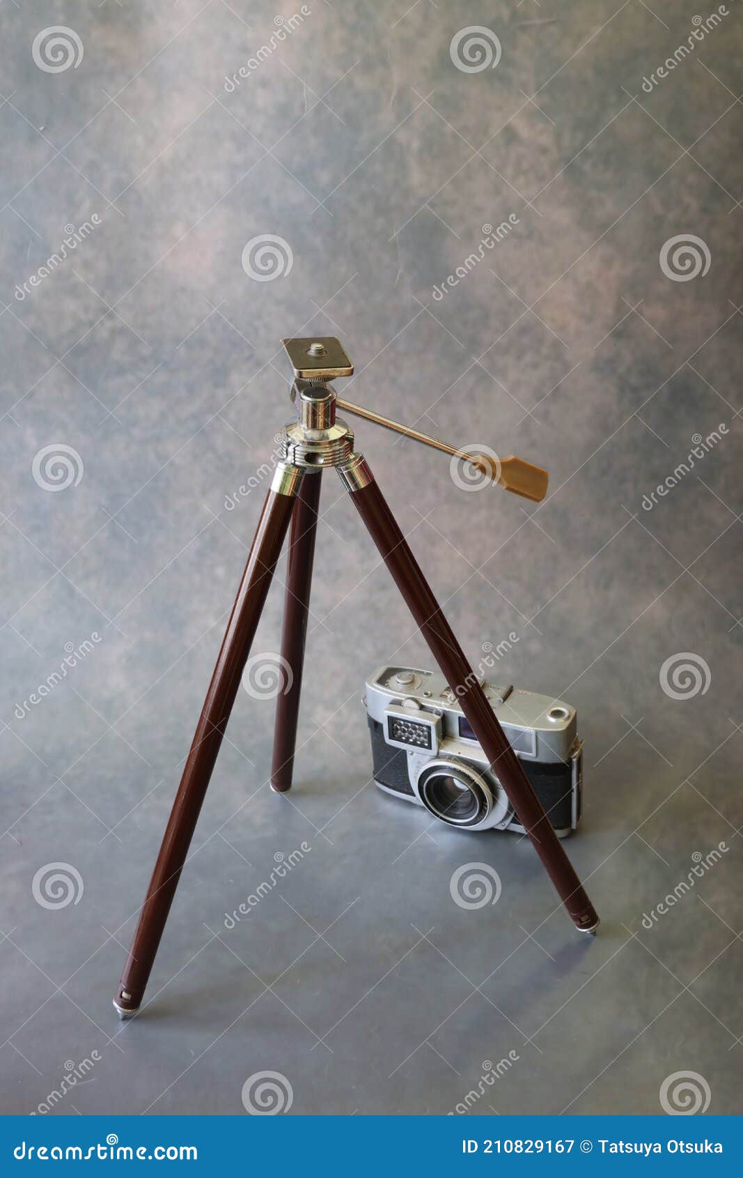 Old Camera and Tripod in a Concrete Pattern Background Stock Image ...