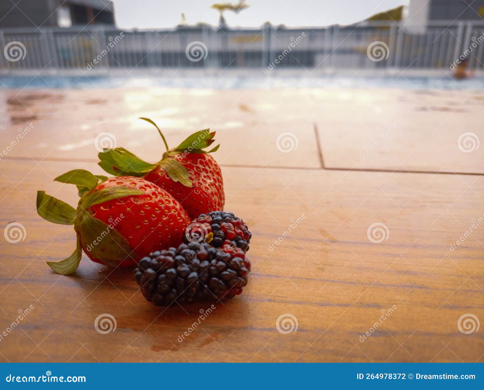 Pictures of Strawberries and Blueberries Lying on the Edge of the Pool ...