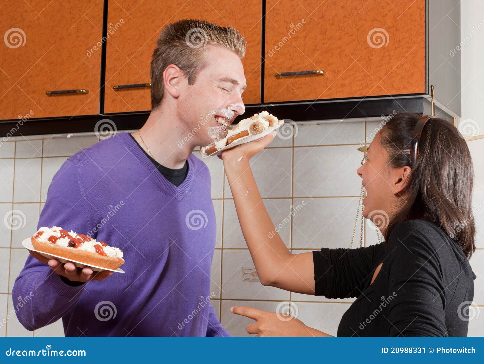 Pie fight in the kitchen stock image. Image of couple - 20988331