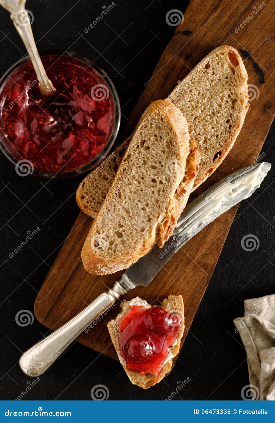 Piece of Bread Smeared with Butter and Jam on the Wooden Board Stock ...