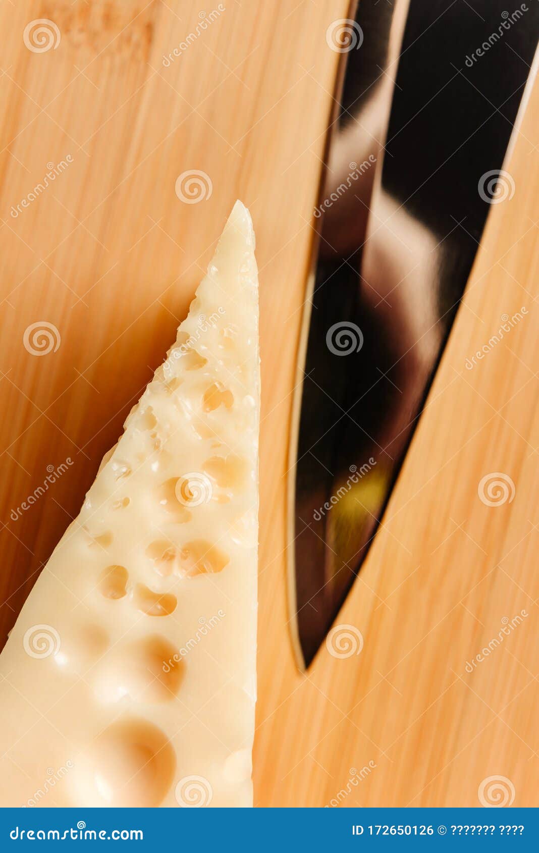 A Piece of Cheese of a Triangular Shape Lies on a Wooden Board Stock ...